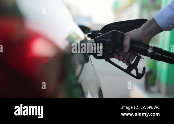 Refueling a car at a gas station. Hand holding and recording the ...