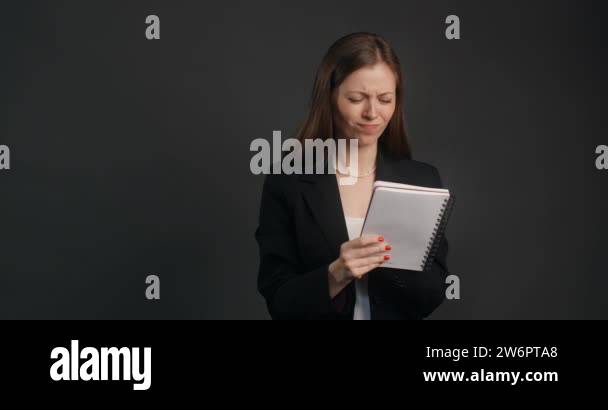 Vexed and angry woman in black suit crosses out hes notes in the ...