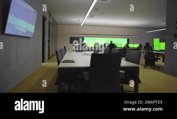 Empty office, desk, and chairs at a main CCTV security data center with ...