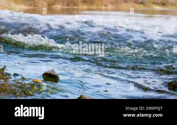 A stream in a pond, a stream of mountain water. River background. Water ...