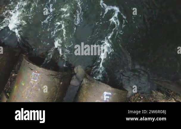 Flying over concrete sewers. Streams of water flow through concrete ...