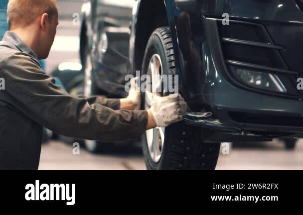 Master checks the bearing of wheel first shakes it left and right then ...