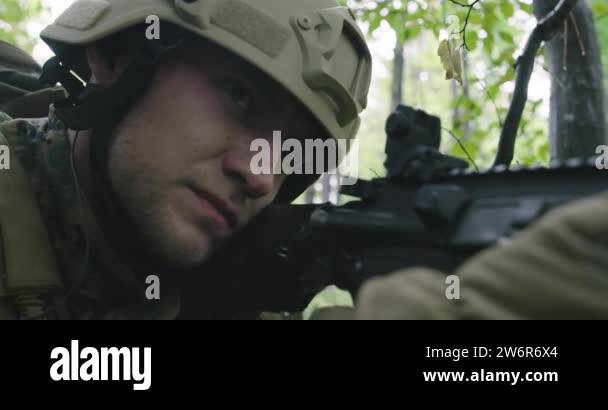 Fully equipped rifle soldier wearing camouflage uniform attacking enemy ...
