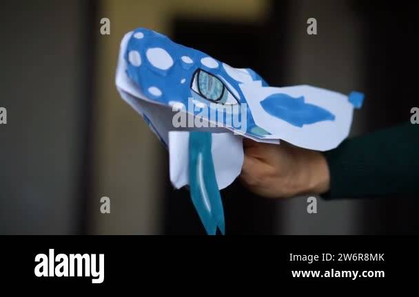 Blue origami dragon with long tongue in child hands, paper dragons ...