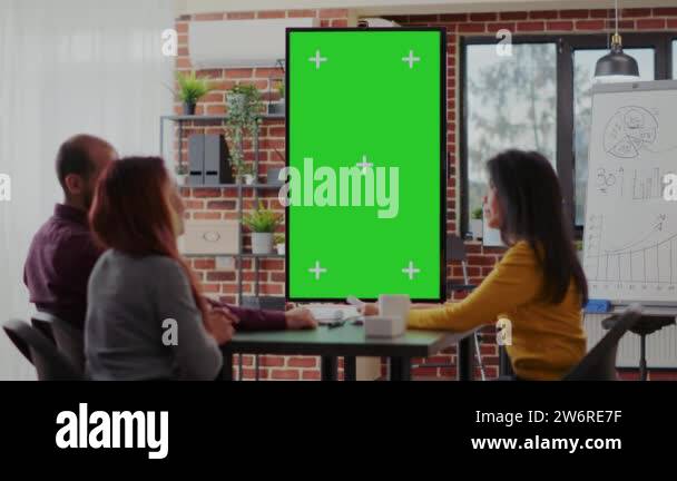 Employees using green screen on monitor vertically in boardroom Stock ...