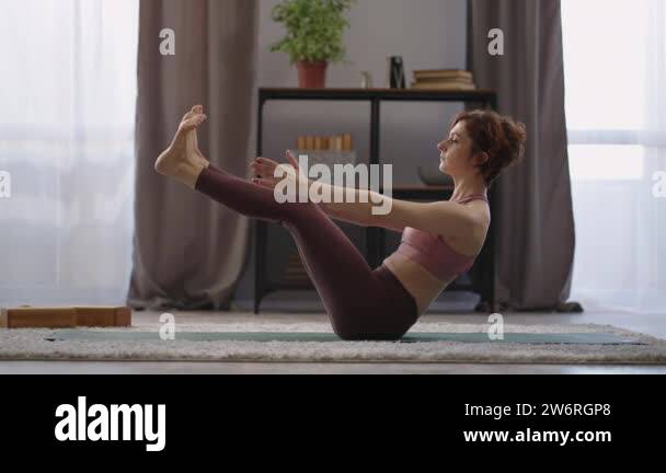 slender woman is keeping fit, doing exercises for slim figure and ...