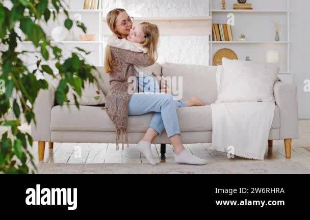 Caring loving mother adult woman babysitter hugs cuddles embrace little ...