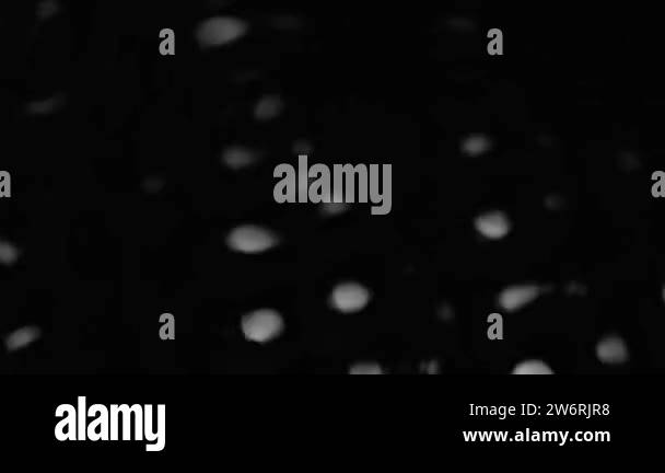 Splashes and drops on the surface of the liquid. Abstract Black ...