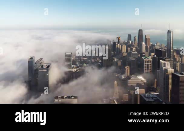 Aerial skyline urban time lapse of heavy fog flowing towards downtown ...