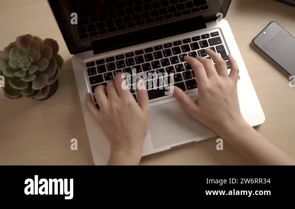 Woman works for a computer in the office or at home online. Hands ...