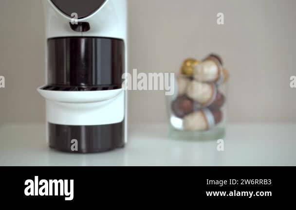 Modern coffee capsule machine on the table in the office with copy ...