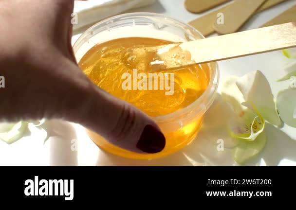 Sugar paste in a transparent jar on a white background. A master stir ...