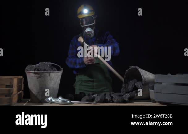 A miner holds a pickaxe and moves it from one side to the other. A mine ...