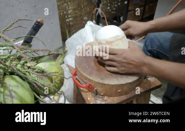 Peeling Thai coconut skin in the traditional way. Which keeping coconut ...