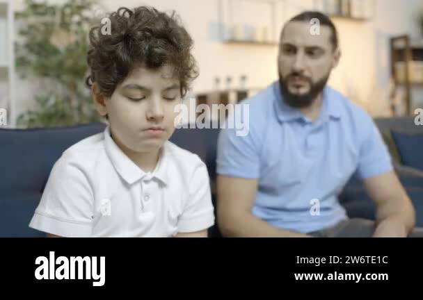 Strict father scolding son, criticizing sad little boy for mistake ...