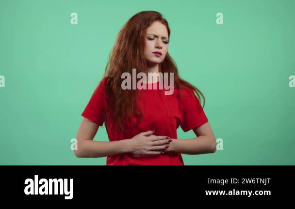 Woman squeezing belly with hands because of abdominal pain. Lady ...