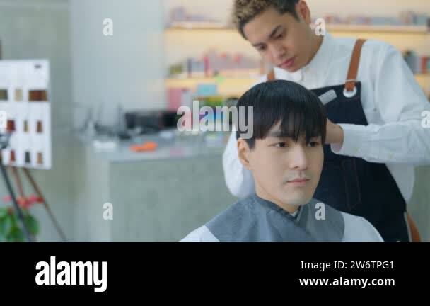 A Professional Barber Asian Man Uses Scissors And Combs To Trim Hairs