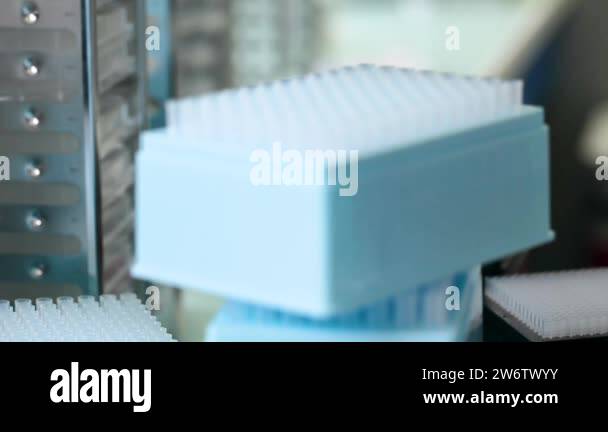 Samples tubes and a functioning automated machine in a laboratory. The ...