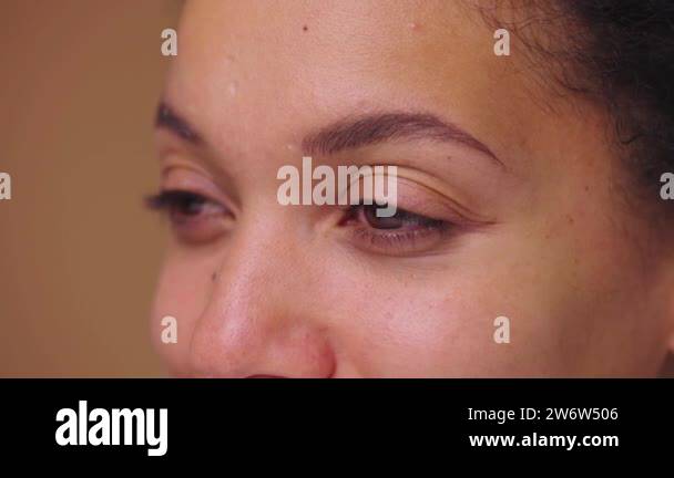 Brown female eyes look seriously to the side. African American woman ...