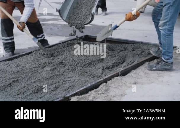 Closeup shot of concrete casting on reinforcing metal bars of a slab on ...