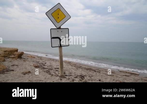 Two road signs indicating the direction of the main road stand on the ...