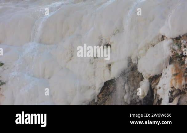 White travertine rock formed with the calcium carbonate mineral in the ...