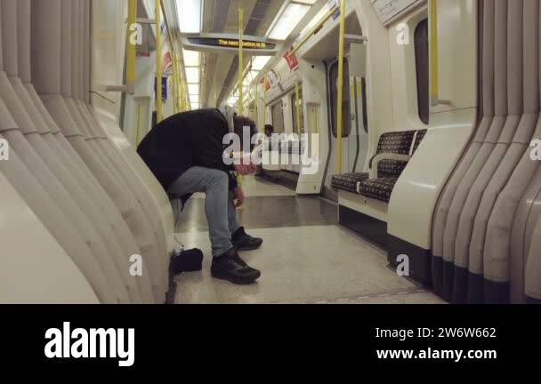 Drunk man sleeping on the District Line train in London Underground ...