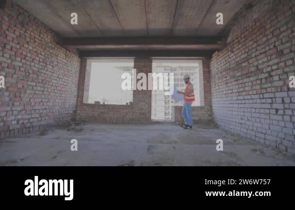 Builders inside a new building. Engineers with a blueprint inside a new ...