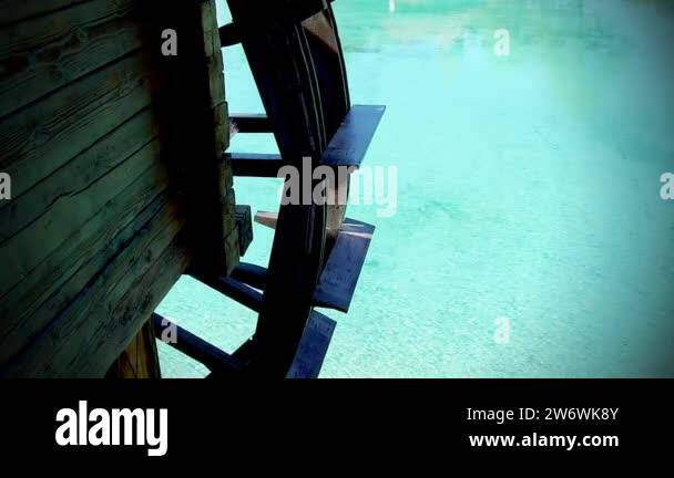 Old water mill. Mill wheel movement. HD video. Splashes and streams of ...