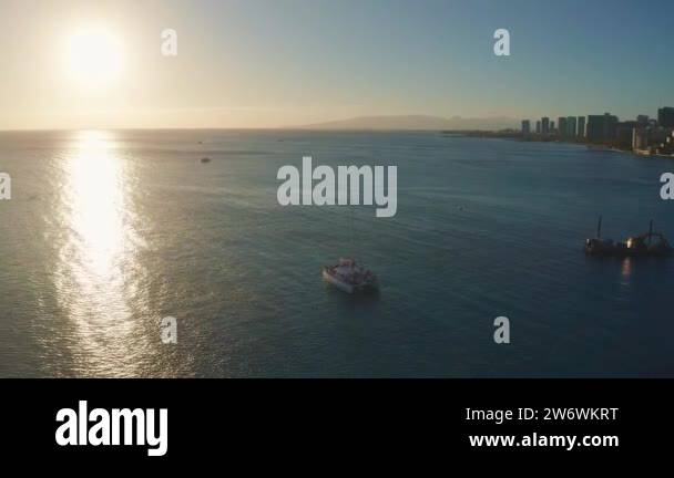 Panning aerial drone slowly flying over a colorful Honolulu Skyline ...