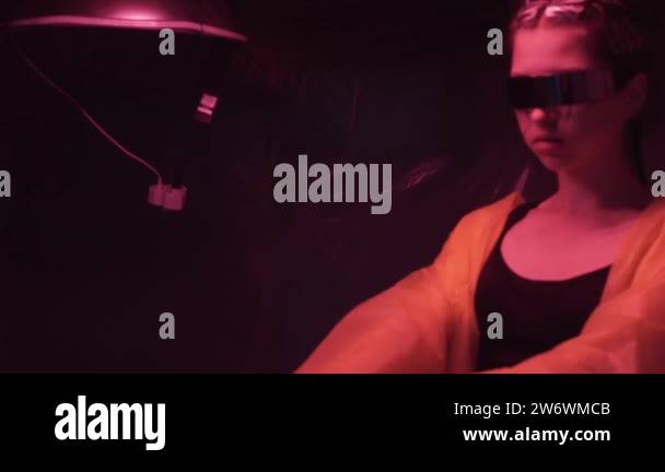 Cyberpunk future concept. Female half-robot bionic cyborg takes aim and ...