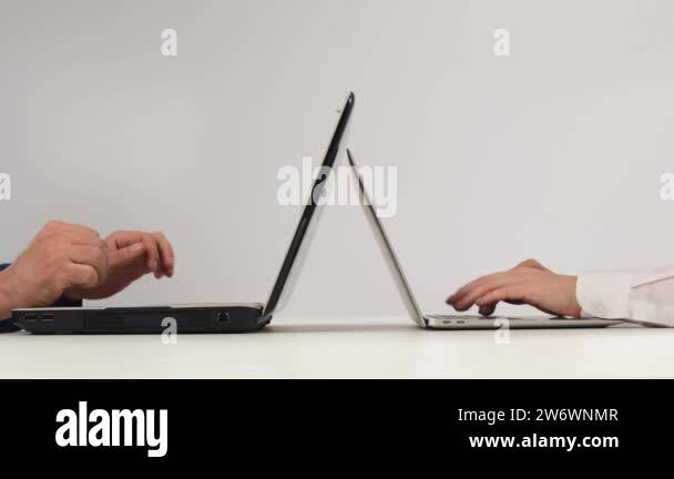Man and woman work on laptops on a white background. Comparison of fast ...