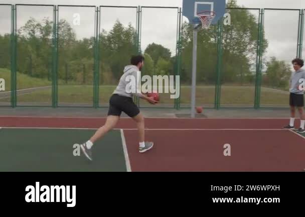 Handheld tracking shot of happy man with dreadlocks running and ...
