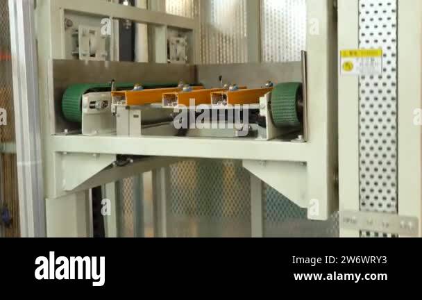 The computer case moves along a conveyor belt and is loaded into an ...