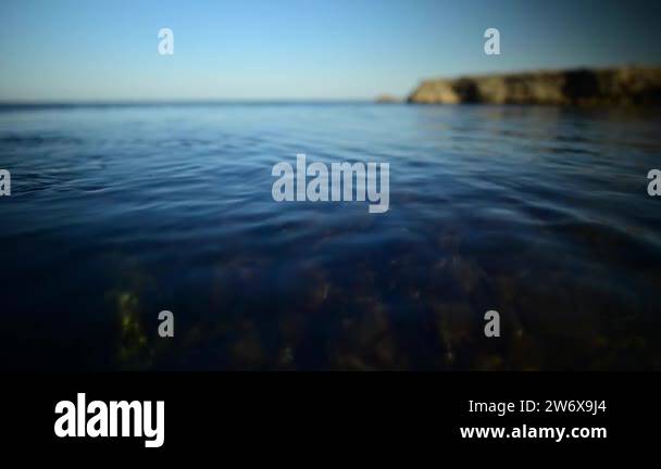 Slow motion over the surface of sea water. Shallow depth of field ...