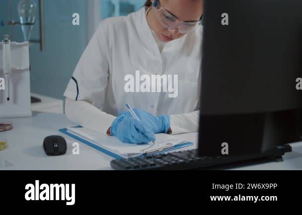 Woman chemist taking notes using Stock Videos & Footage - HD and 4K ...