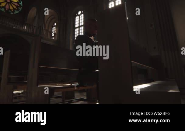 Tracking left of African-American pastor wearing black clothes and ...