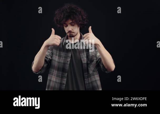 The cheerful young man, with a sincere smile, points to him, then the ...