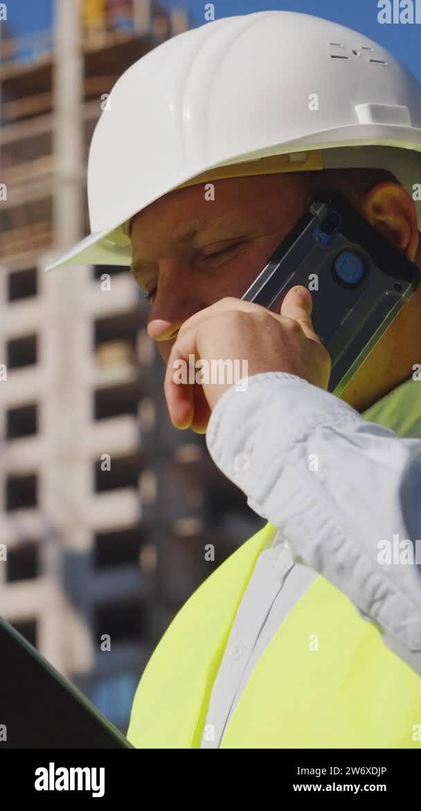 Vertical Screen: Civil engineer doing inspection on construction site ...