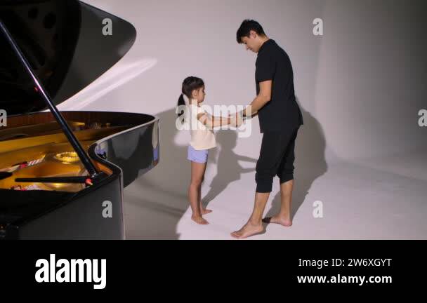 Diligent little ballet student is having individual ballet lesson with ...