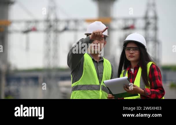 Two engineers working at power plant, helping each other analyze problem Stock Video Footage - Alamy