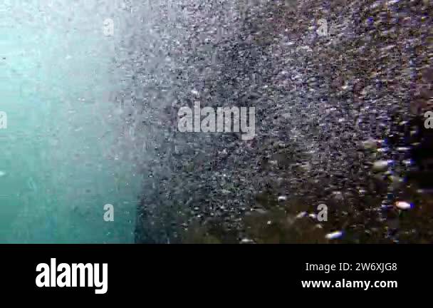 Water churned boils and bubbles underwater of fast flowing waters of ...