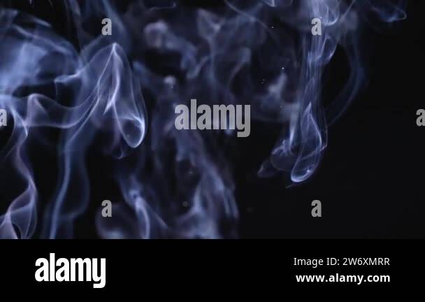 A cloud of white smoke with dust particles floating in space on a black ...