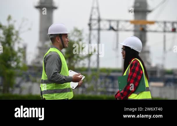 Two engineers working at power plant, helping each other analyze problem Stock Video Footage - Alamy