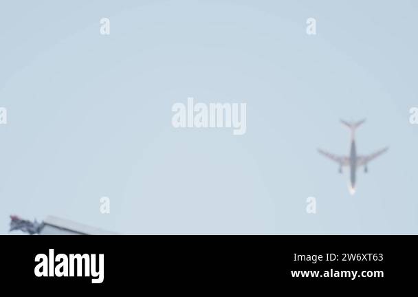 Aeroplane flying in clean blue sky background, bottom view. Action ...