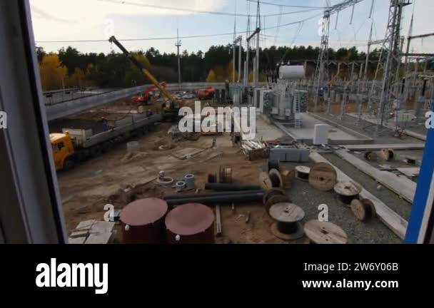Men walk along construction site of electrical substation Stock Video ...