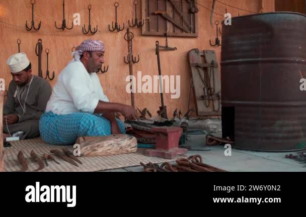 A traditional Arabic blacksmith working in Katara cultural village ...