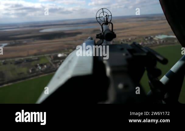 Up-to-date machine gun with a front sight is aimed at land objects from ...