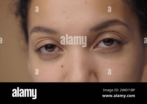 Brown female eyes look straight ahead seriously. African American woman ...