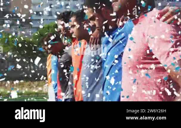 Animation of confetti falling over male football team standing and ...